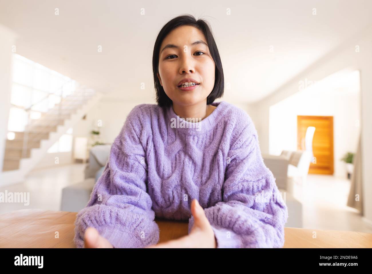 Happy asian woman sitting table hi-res stock photography and images - Alamy