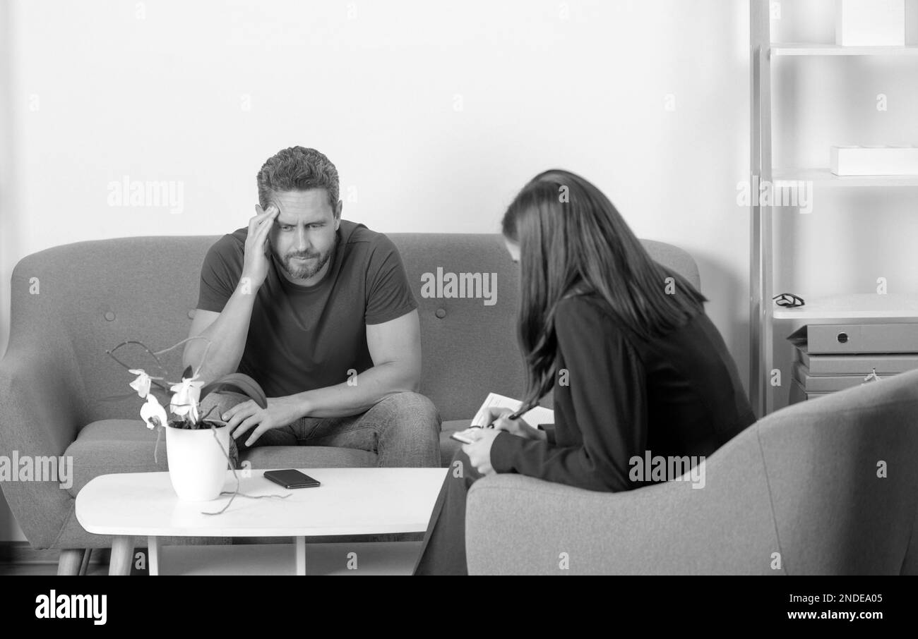 Psychologist helping young man to solve men problems. Depressed middle ...