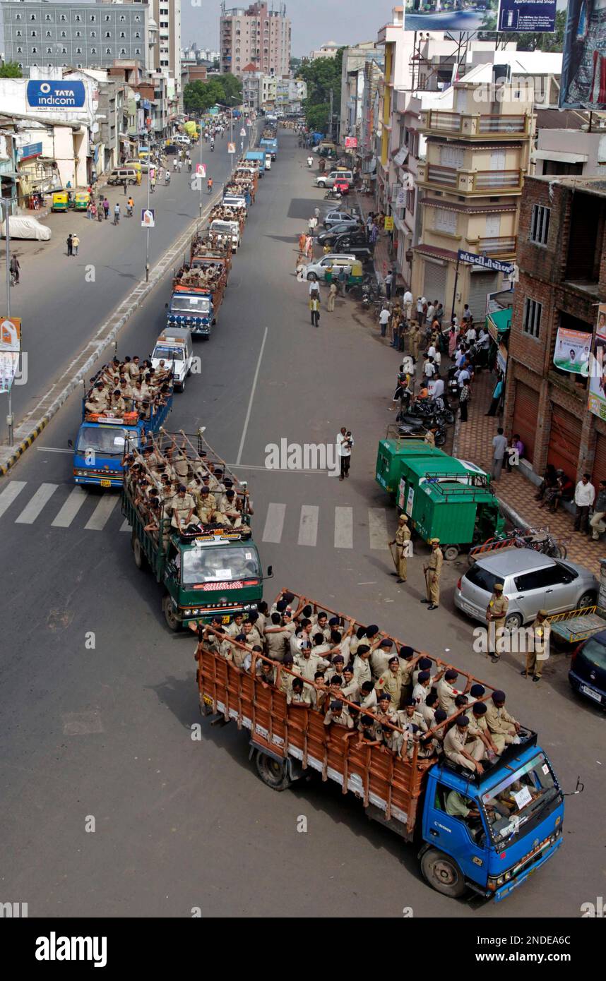 Indian police officers patrol the streets on their vehicles for ahead ...