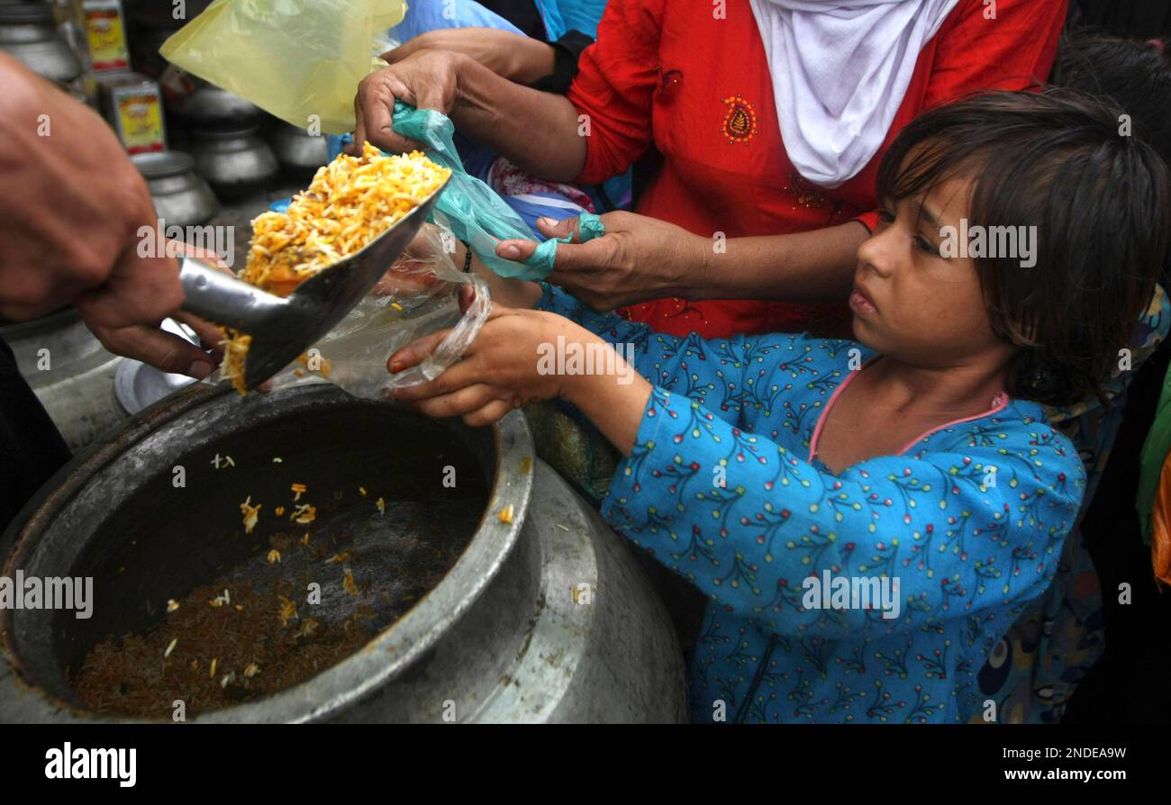 A Pakistani girl gets free food at the shrine of Abdullah Shah Ghazi in ...