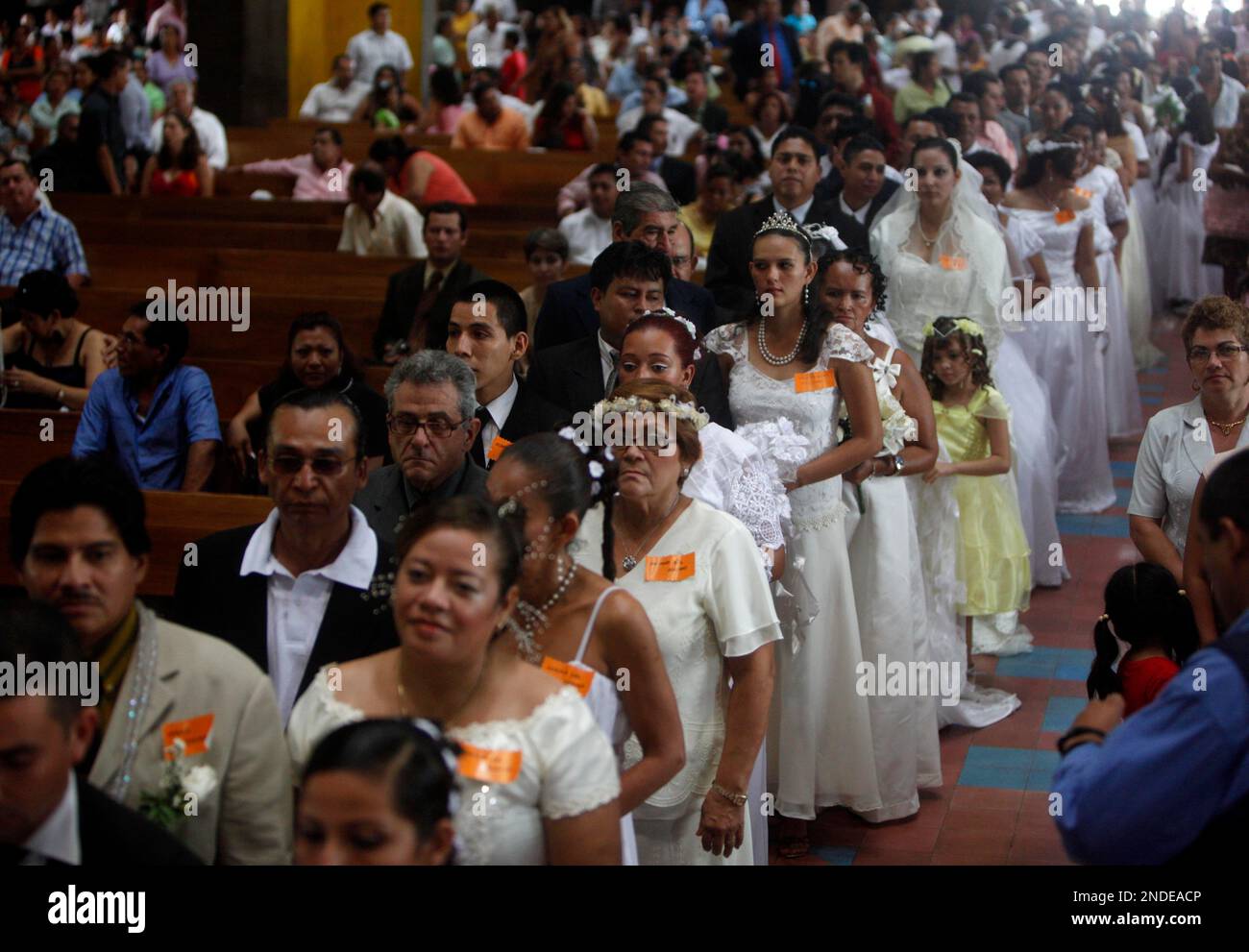 Couples wait in line during a collective wedding at the Metropolitan ...