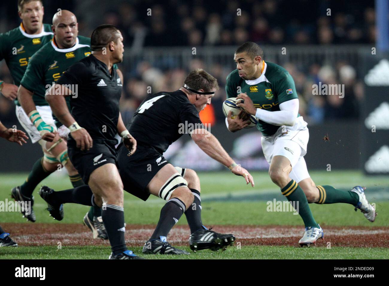 New Zealand's Brad Thorn (4) challenges South Africa's Bryan Habana ...