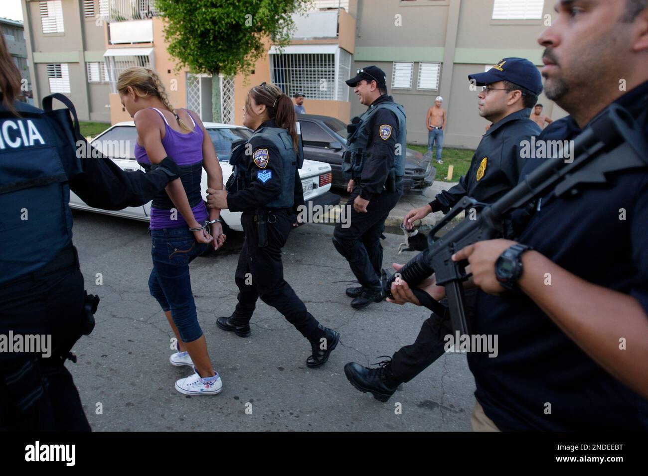 A suspected drug dealer is escorted by Puerto Rico police and DEA ...