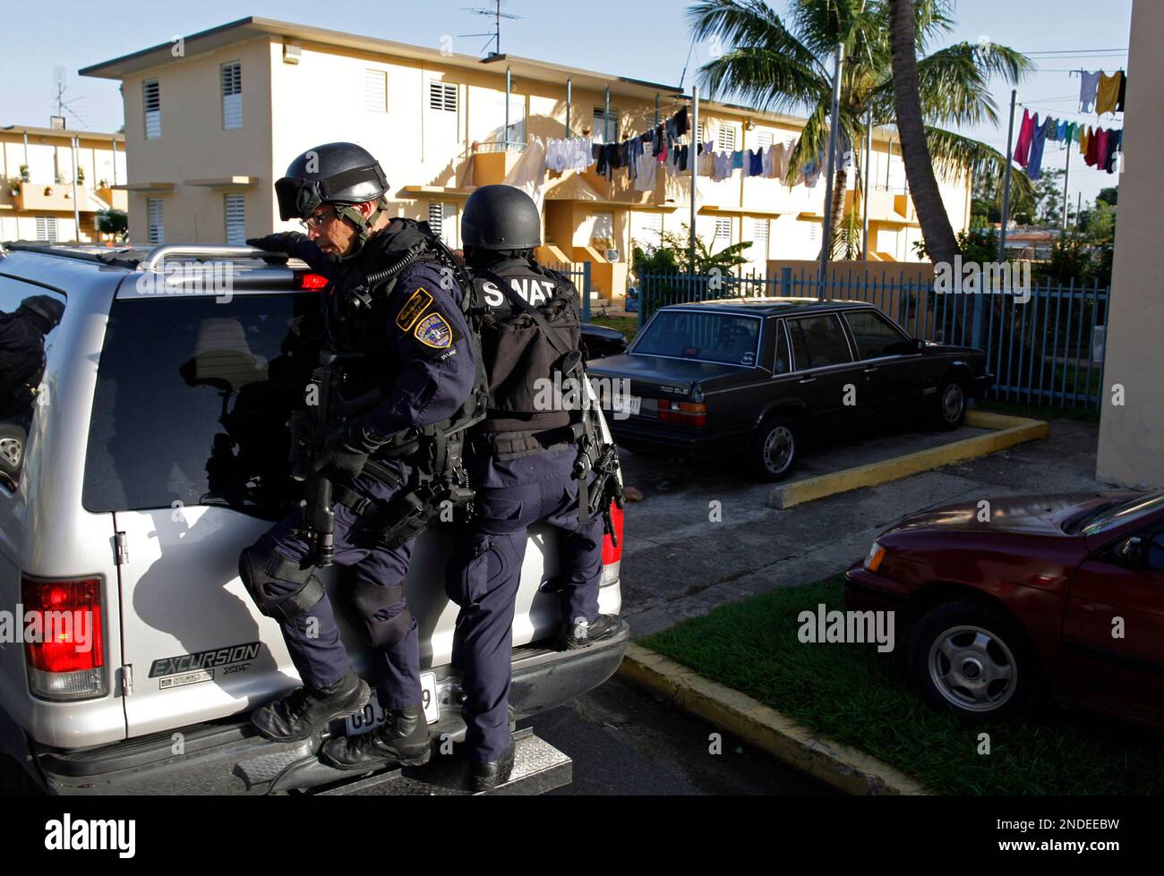 SWAT police arrive to conduct an anti-drug raid at a public housing ...