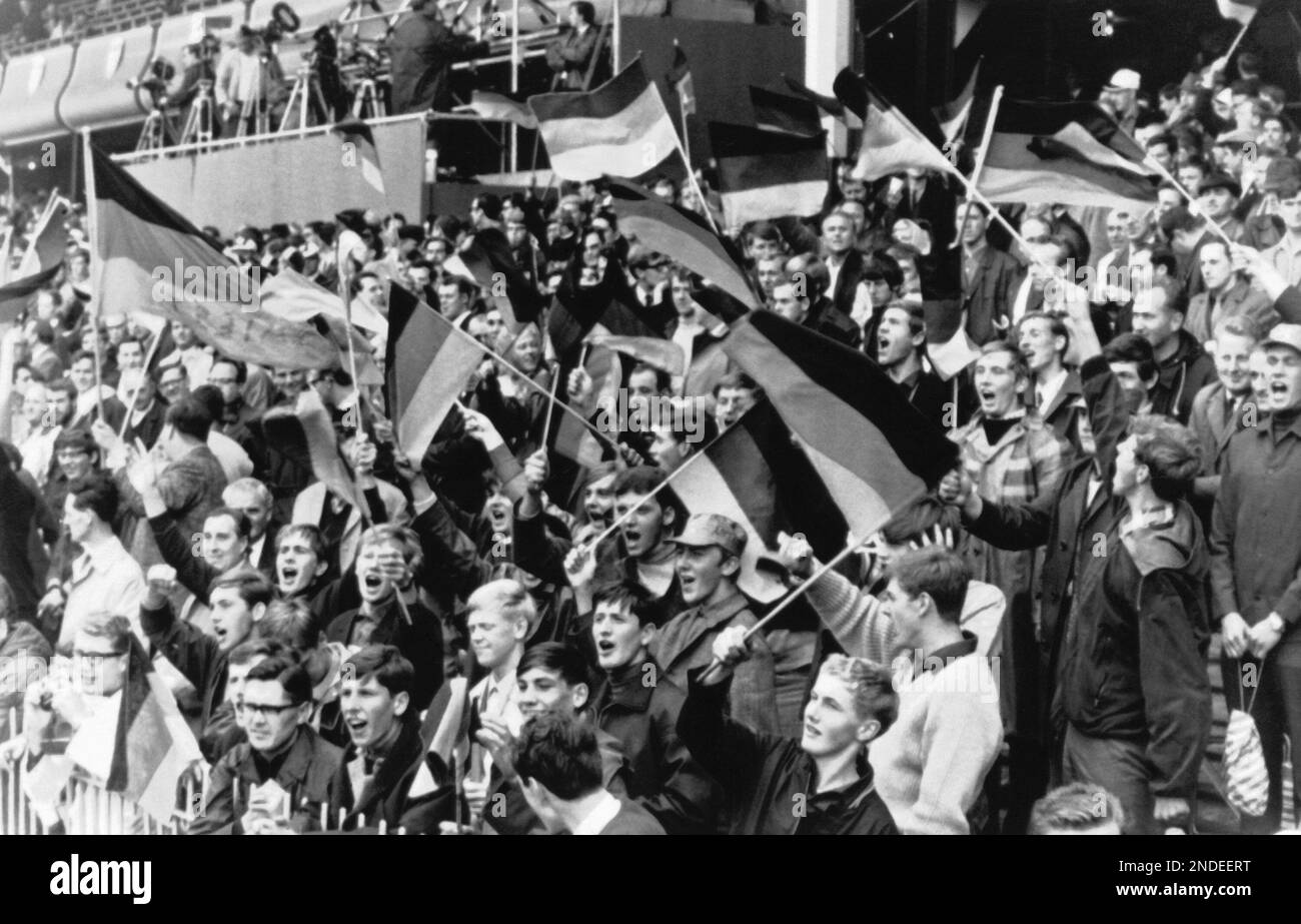 West German soccer fans complete with flags in happy mood before the ...
