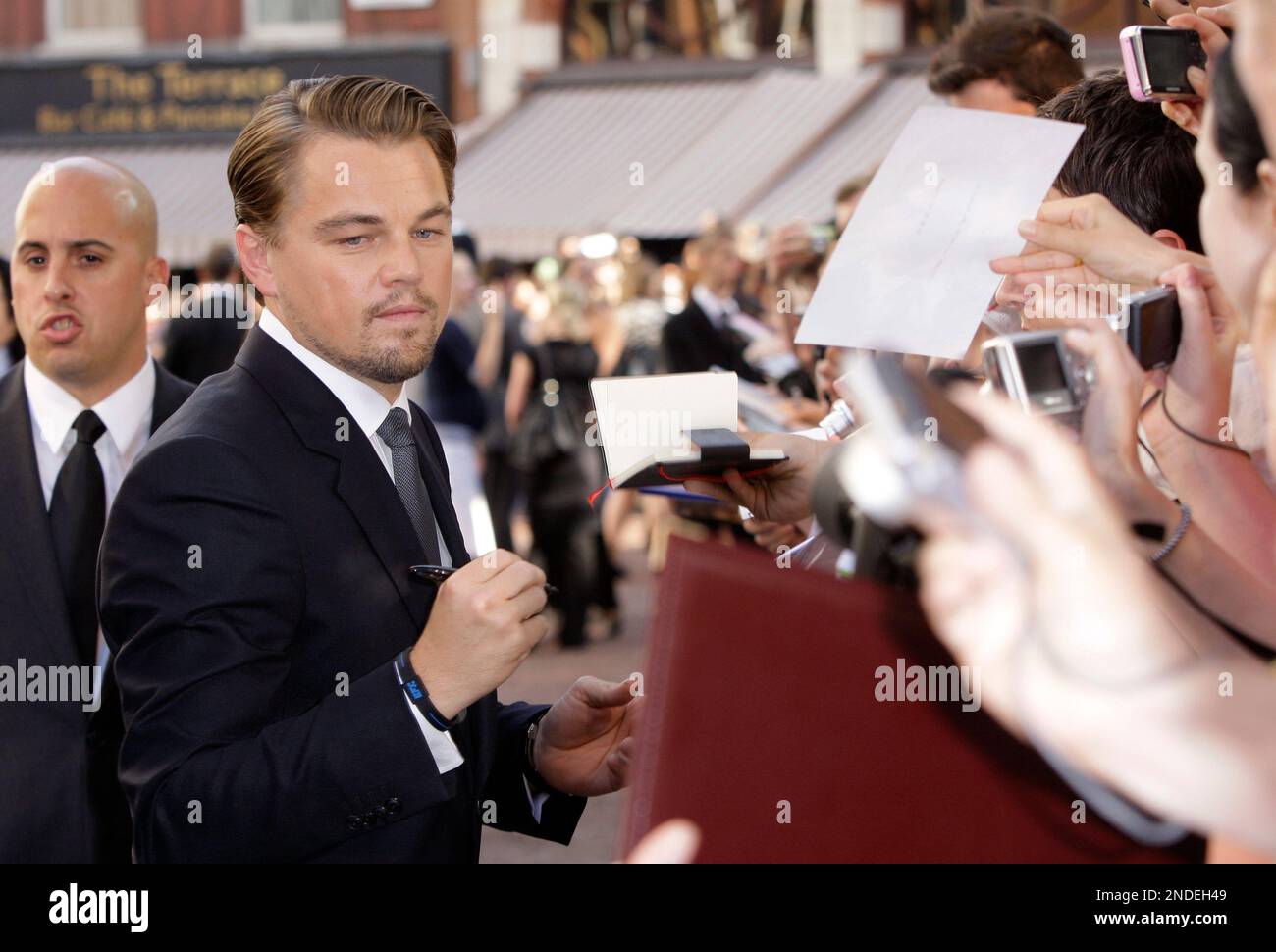 U.S actor Leonardo DiCaprio signs autographs as he arrives at the World ...