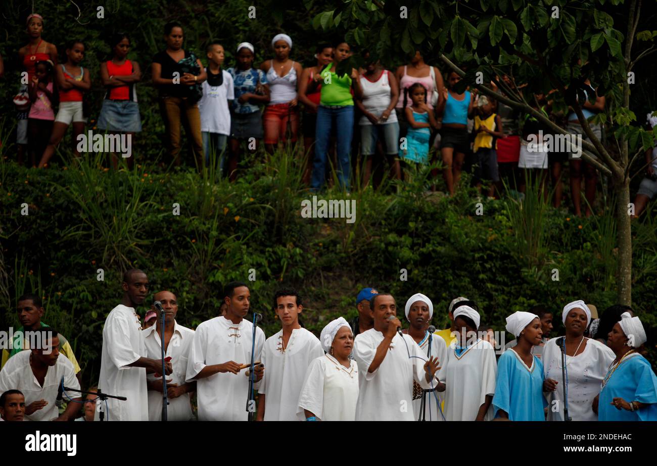 Members of an African-Cuban religious Santeria group sing during a ...