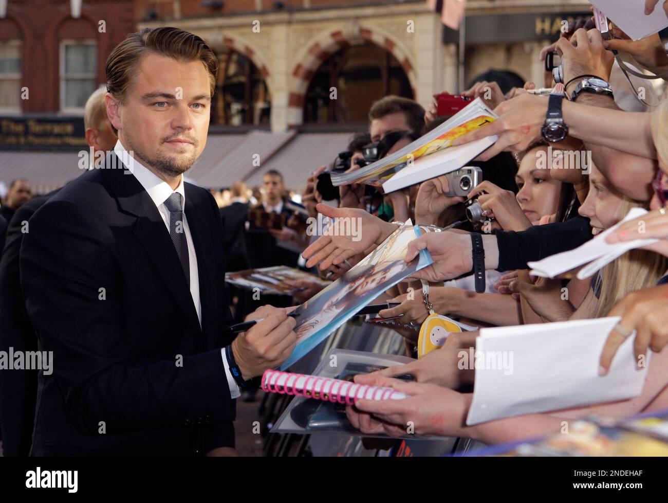 U.S actor Leonardo DiCaprio signs autographs as he arrives at the World ...