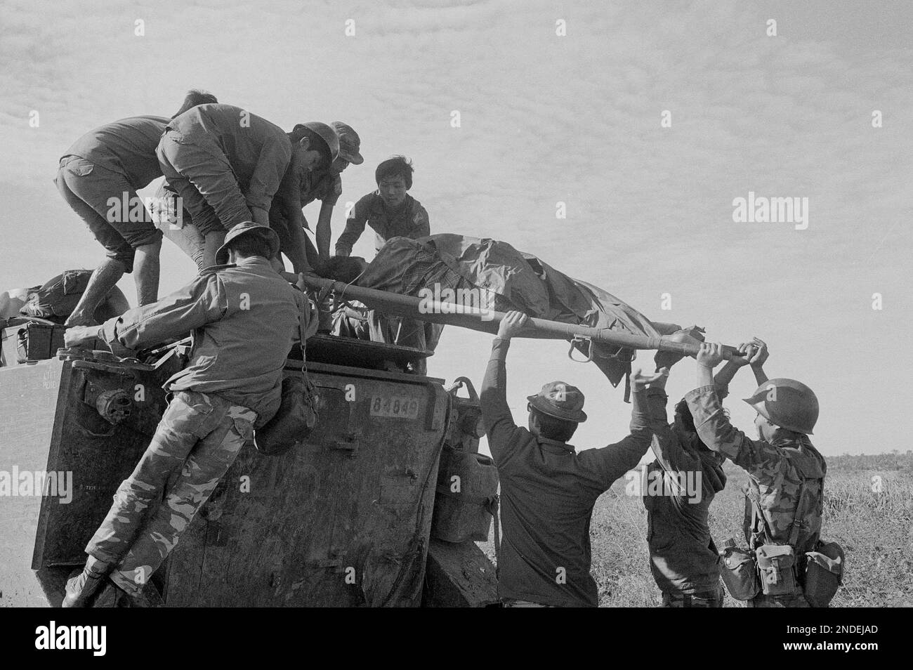 South Vietnamese soldiers lend a hand in lifting stretcher carrying ...