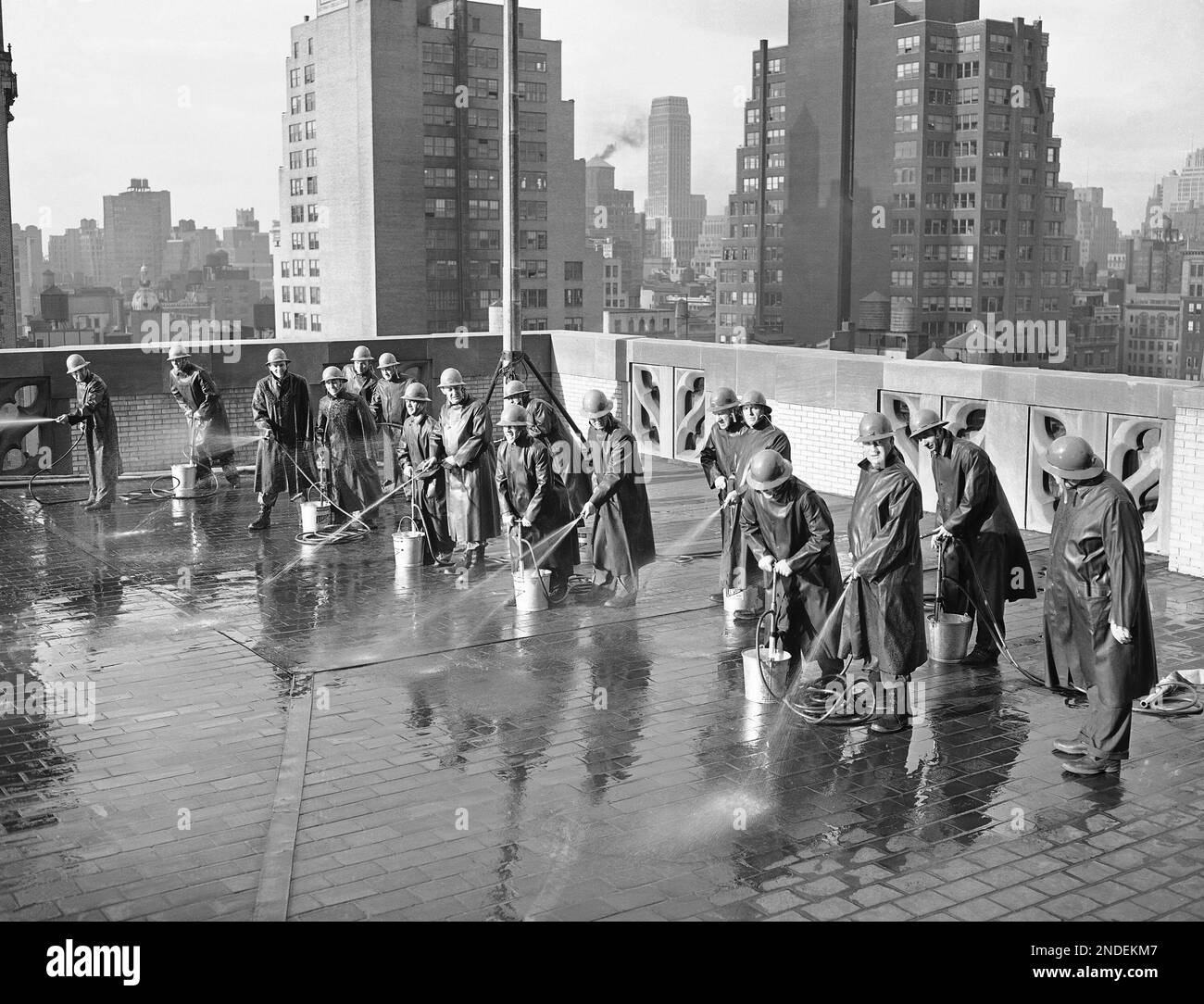 Firefighters of the 34-story New York Life Building demonstrate how ...
