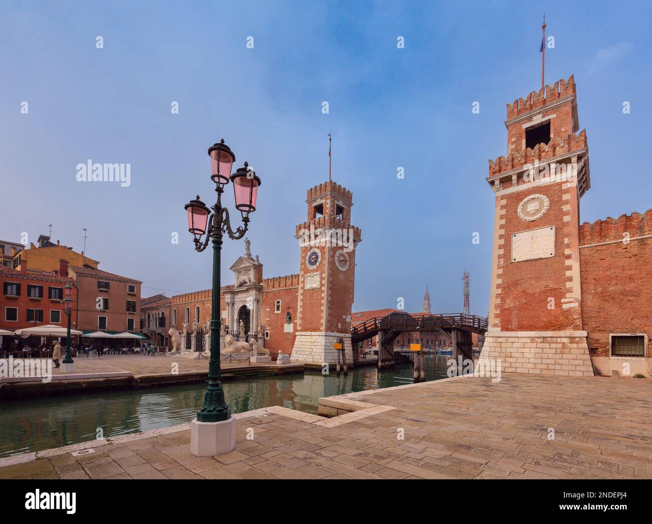 Old medieval armory towers and a bridge across a canal on a sunny day ...