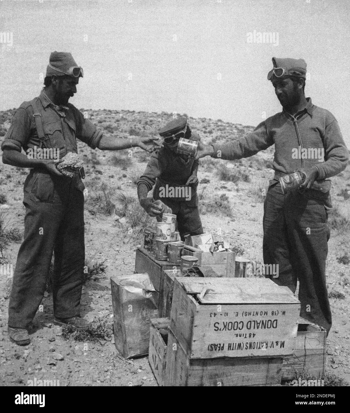 Members of the commandos unpack canned rations, June 22, 1943. (AP ...