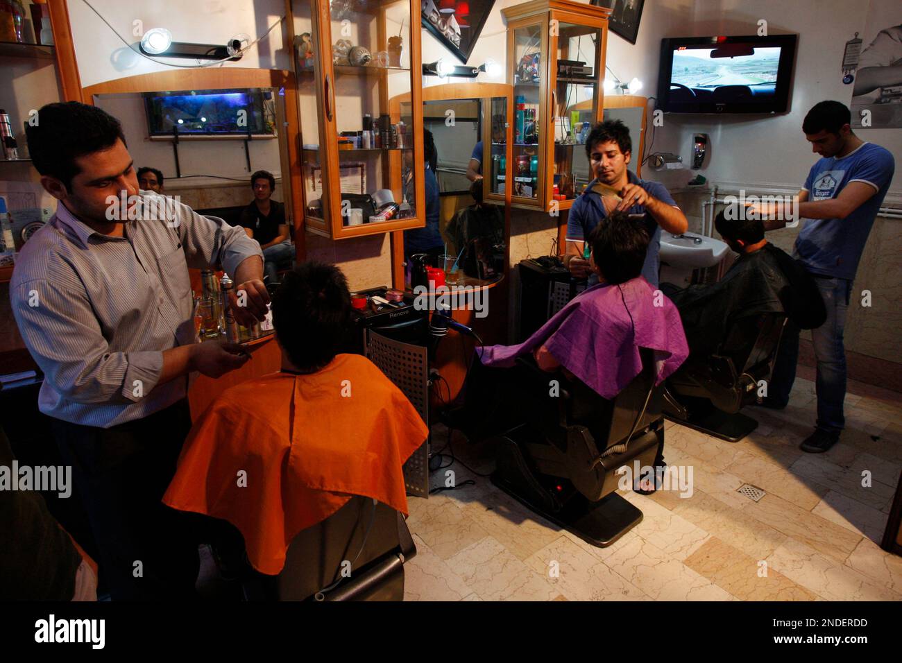 Iranian barbers cut hair in their barber shop in midtown Tehran, Iran ...
