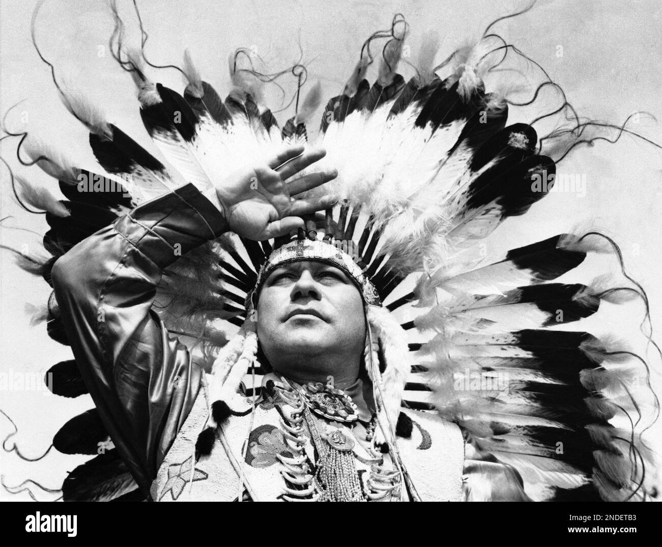 Chief Poling Fire, also known as James R. McComber, shades his eyes and ...
