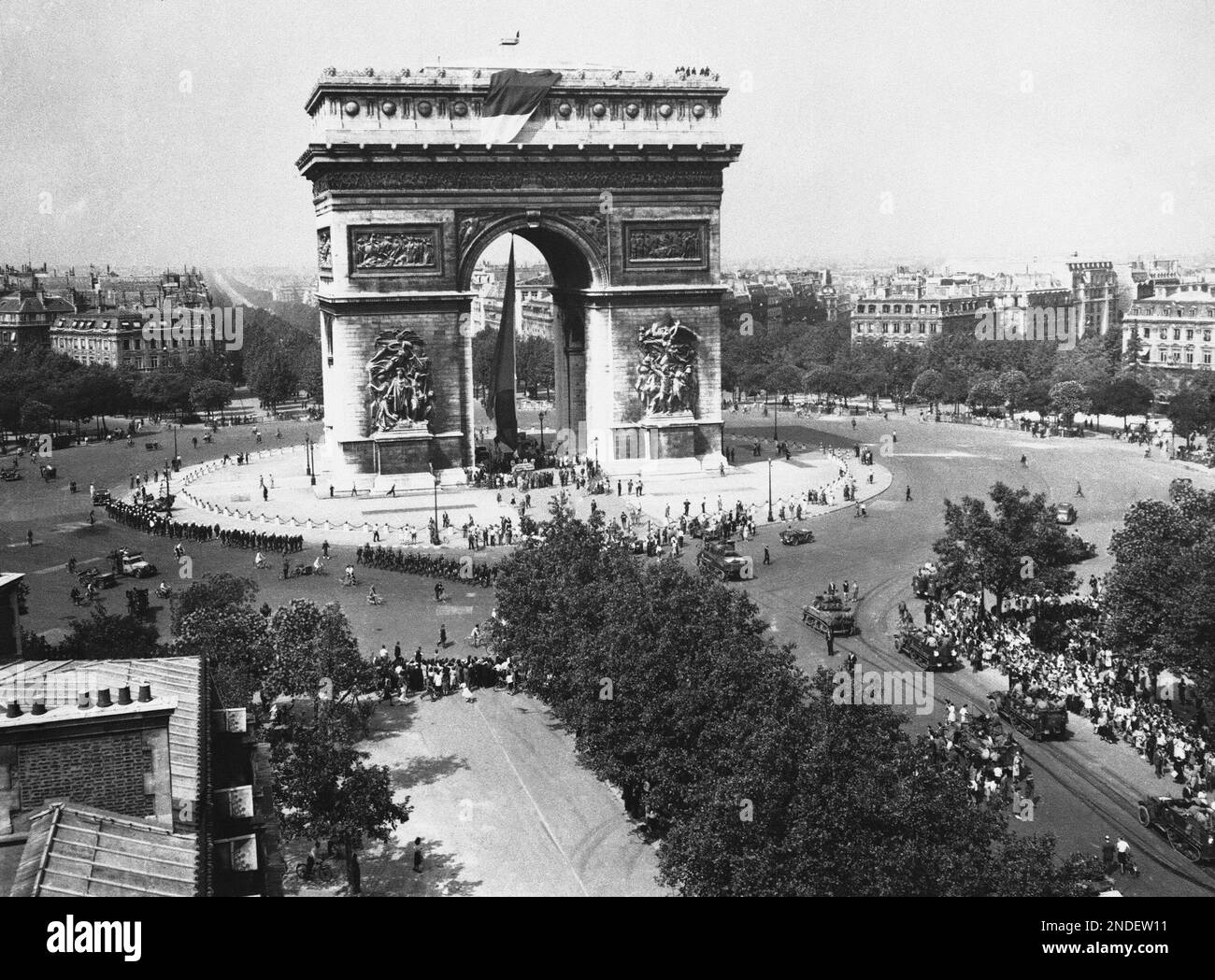 A striking view of the Arc De Triomphe showing the French flag once ...