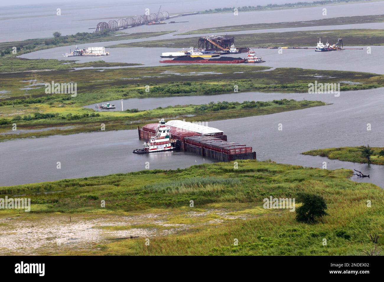 Barges lined up to block oil are seen from the air in The Rigolets ...