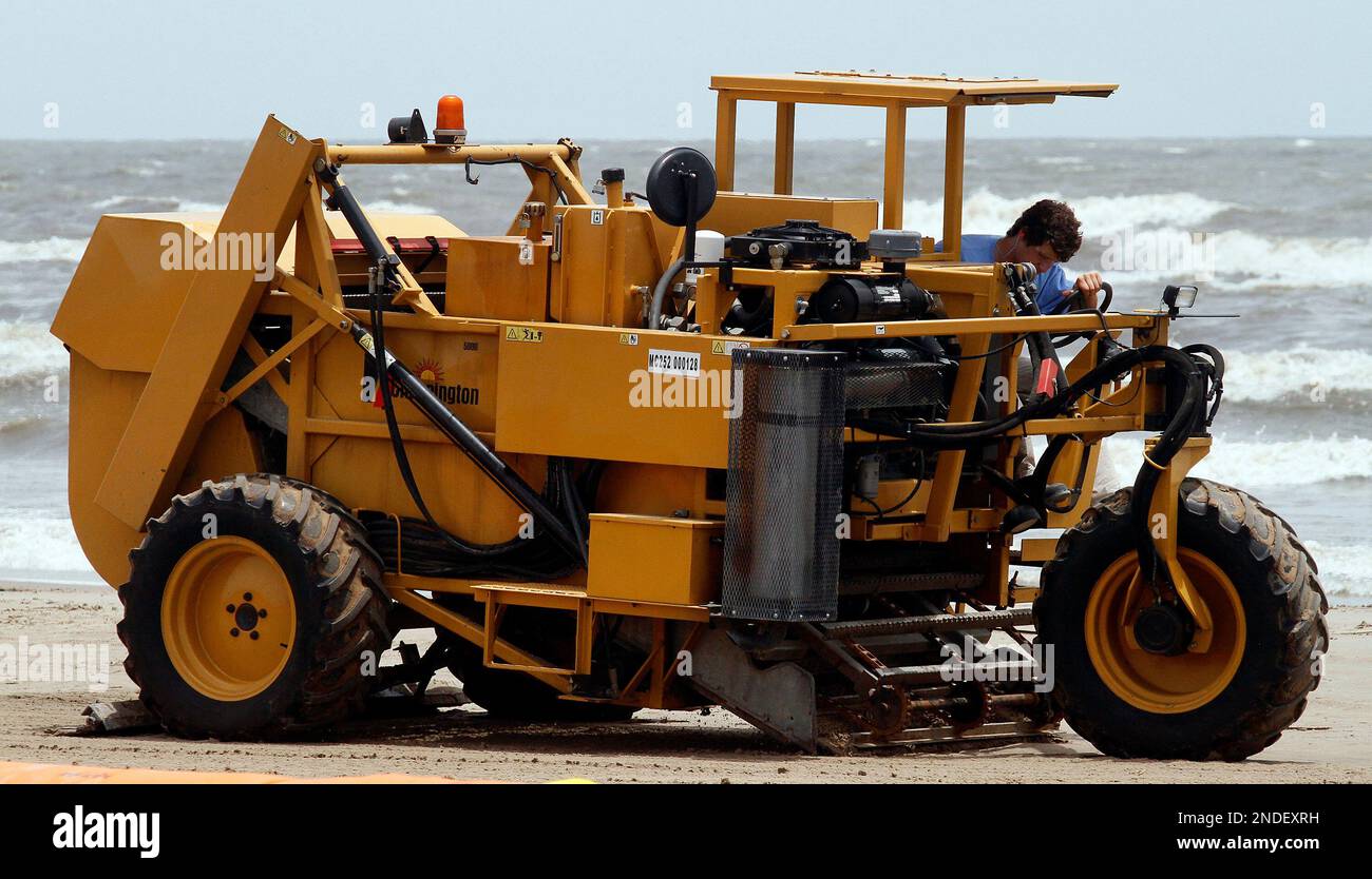 A beach cleaner drives along a beach in Grand Isle, La., Tuesday, July ...