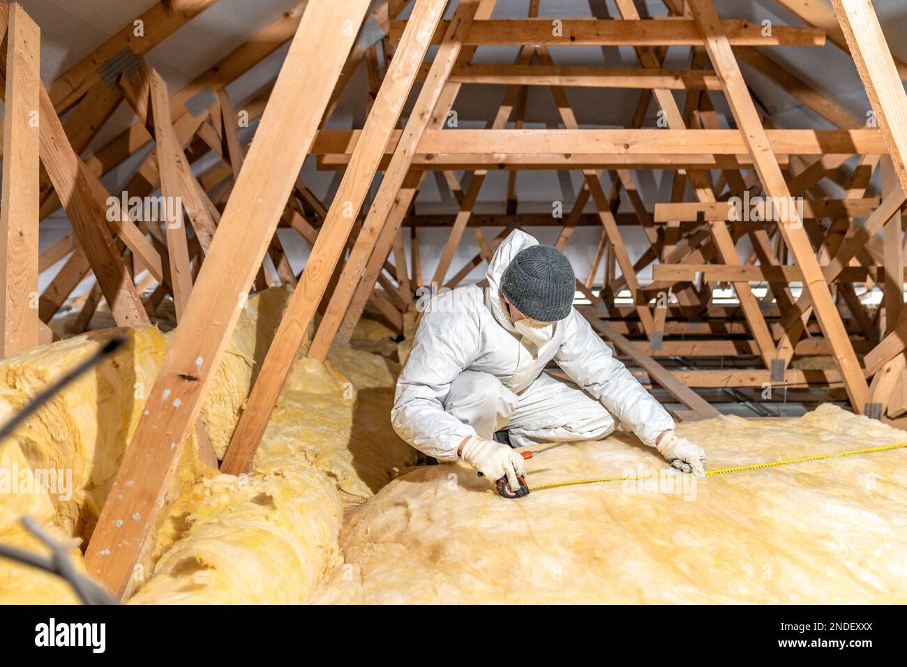 insulation of the roof and ceiling with glass wool Stock Photo - Alamy
