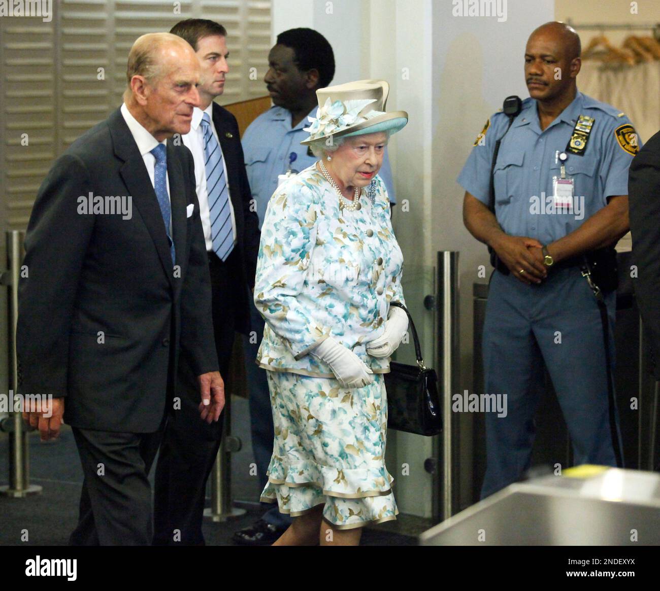 Prince Philip, Duke of Edinburgh, left, trails behind Queen Elizabeth ...