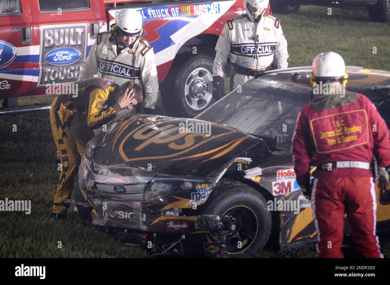 NASCAR driver David Ragan, left, looks over the damage to his car after ...