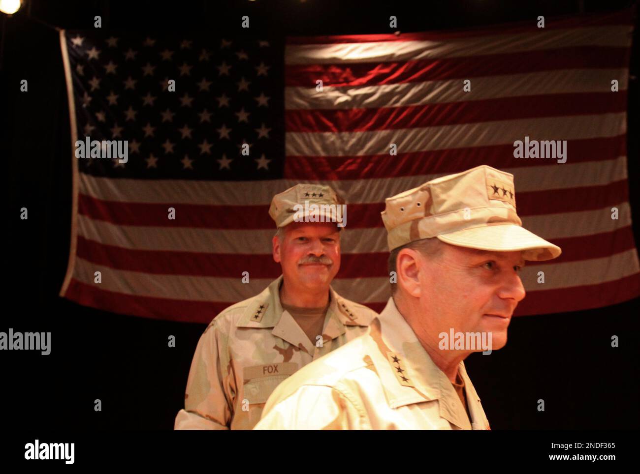 U.S. Navy Vice Adm. Mark Fox, left, smiles in front of the U.S. flag as ...