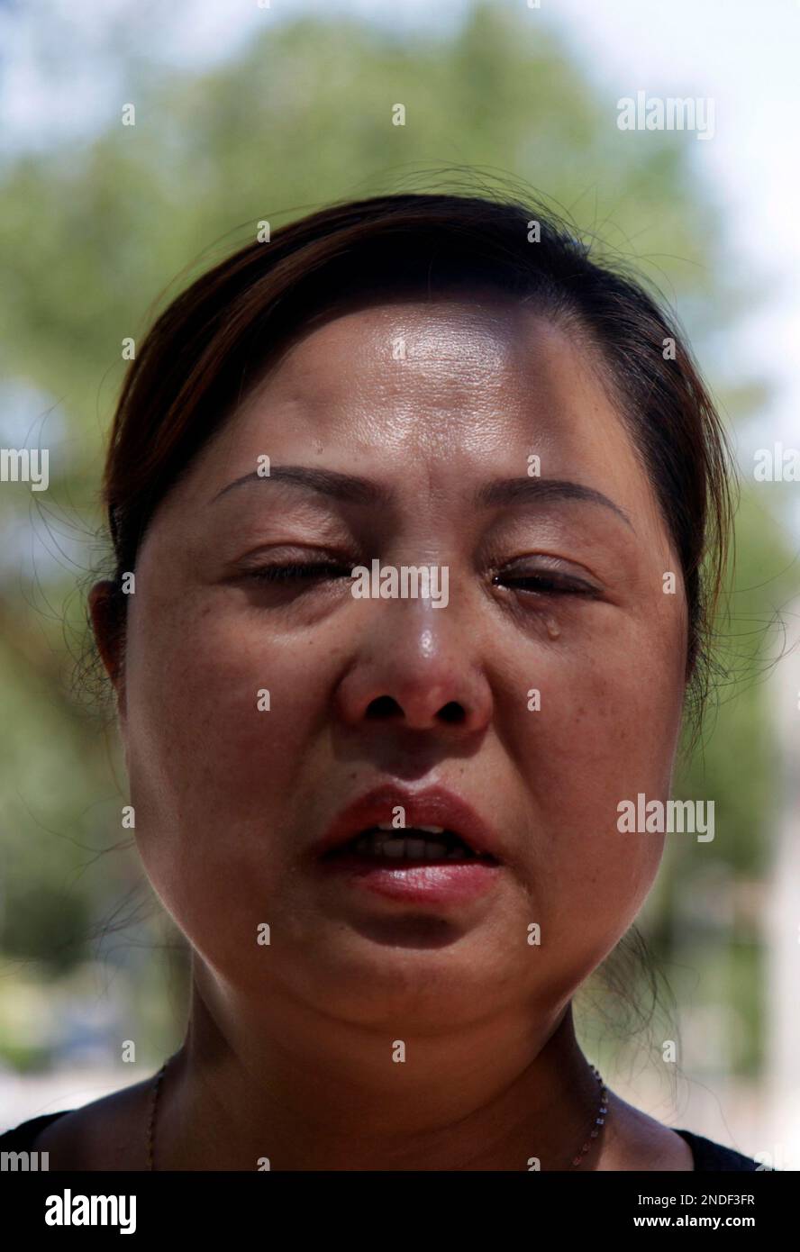 Xue Min cries as she recalls meeting her brother Xue Feng at the ...