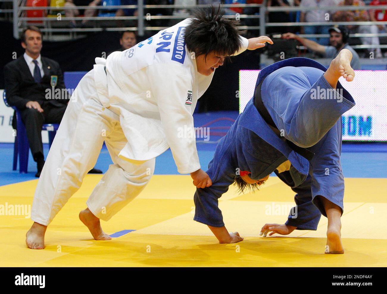 Japan's Megumi Tachimoto, left, and China's Qian Qin compete during the ...