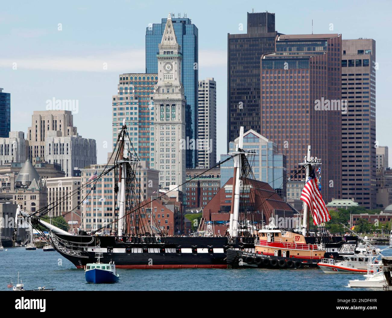 The USS Constitution moves past the Boston skyline on its annual July ...