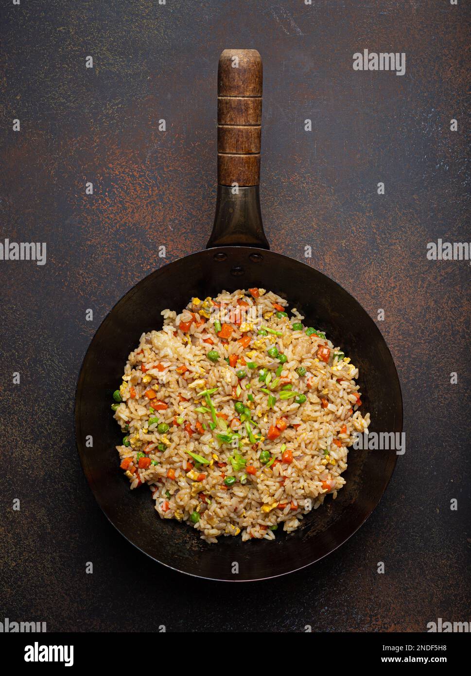 Authentic Chinese and Asian fried rice with egg and vegetables in wok ...