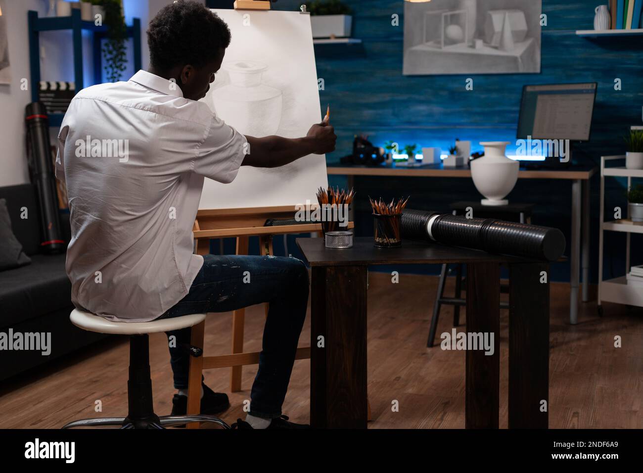 Drawing student finishing homework of creating artwork. Young african ...