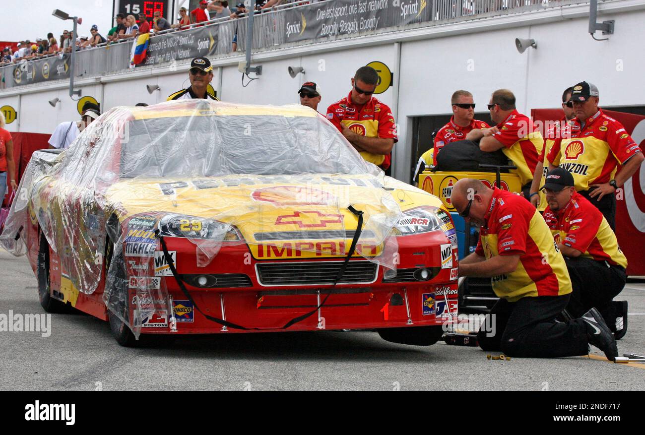 The crew of NASCAR driver Kevin Harvick checks out the car in the ...