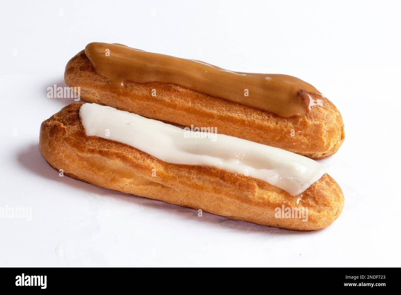Coffee eclair and vanilla eclair pastry on white background Stock Photo ...