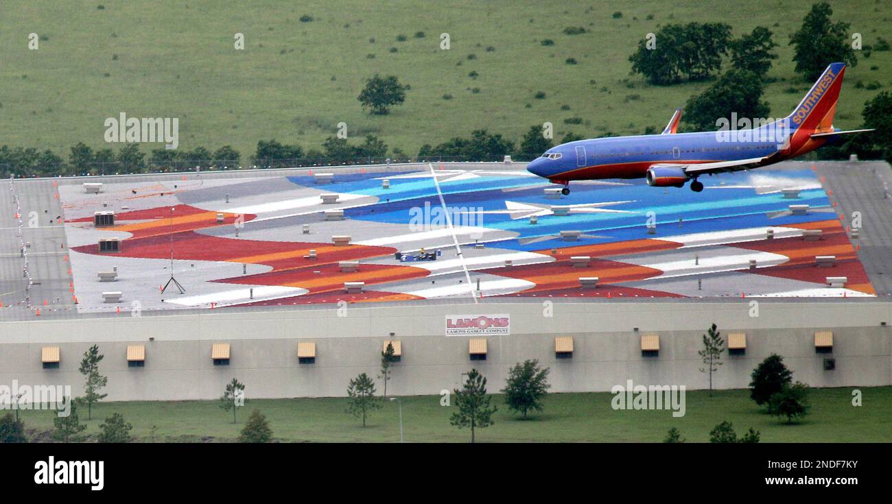 A Southwest Airlines jet passes Lamons Gasket Company as it lands at ...