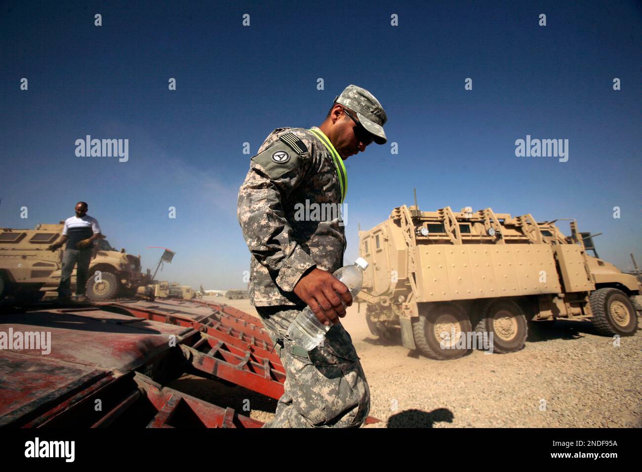 US Army Sgt. Norberto Rodriguez disembarks from a flat bed truck while ...