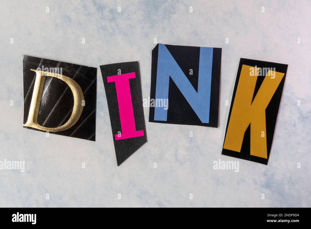 The acronym "DINK" (Dual Income no Kids) using cut-out paper letters in ...