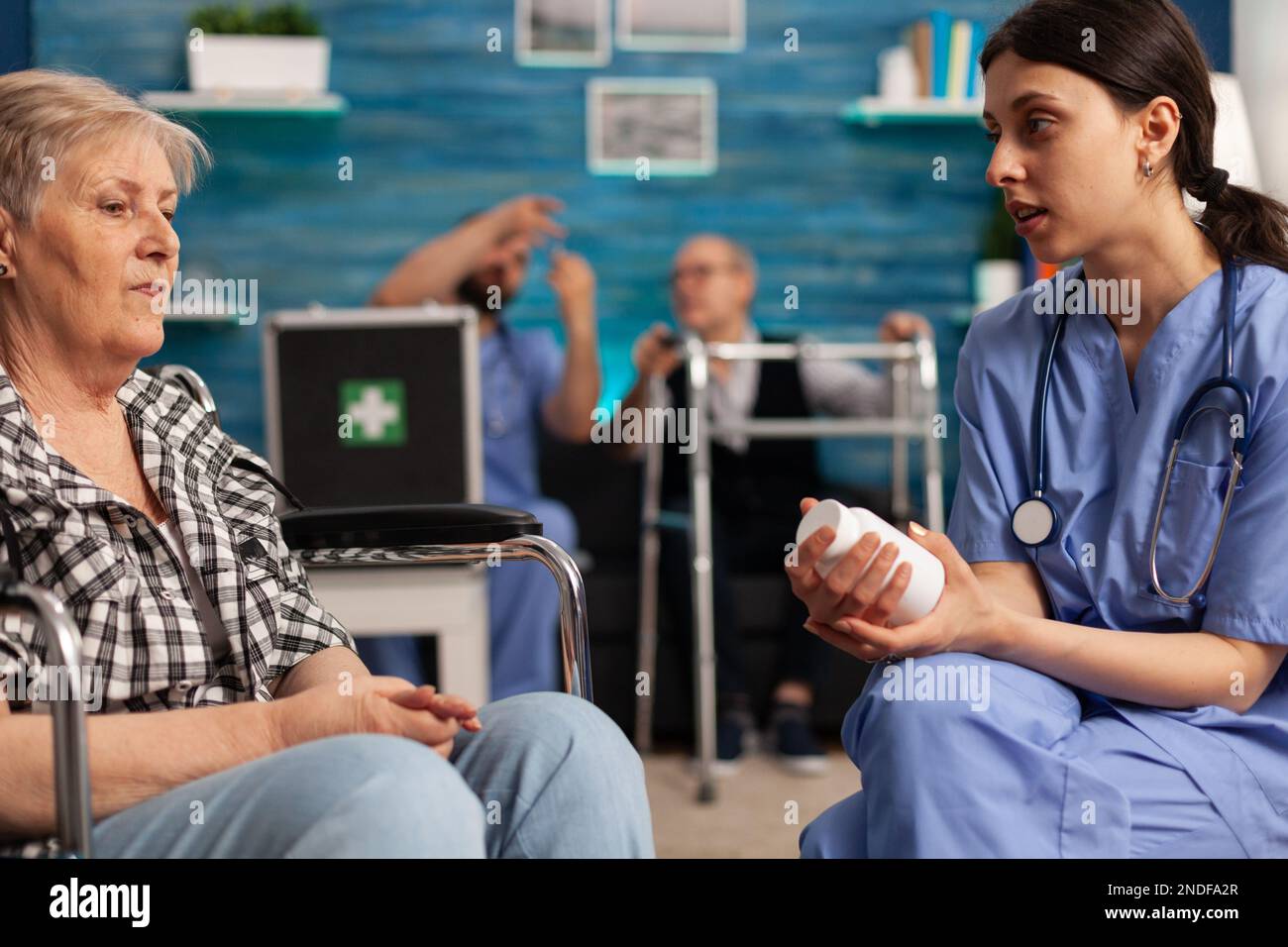 Nurse explaining to senior female patient instructions on taking ...
