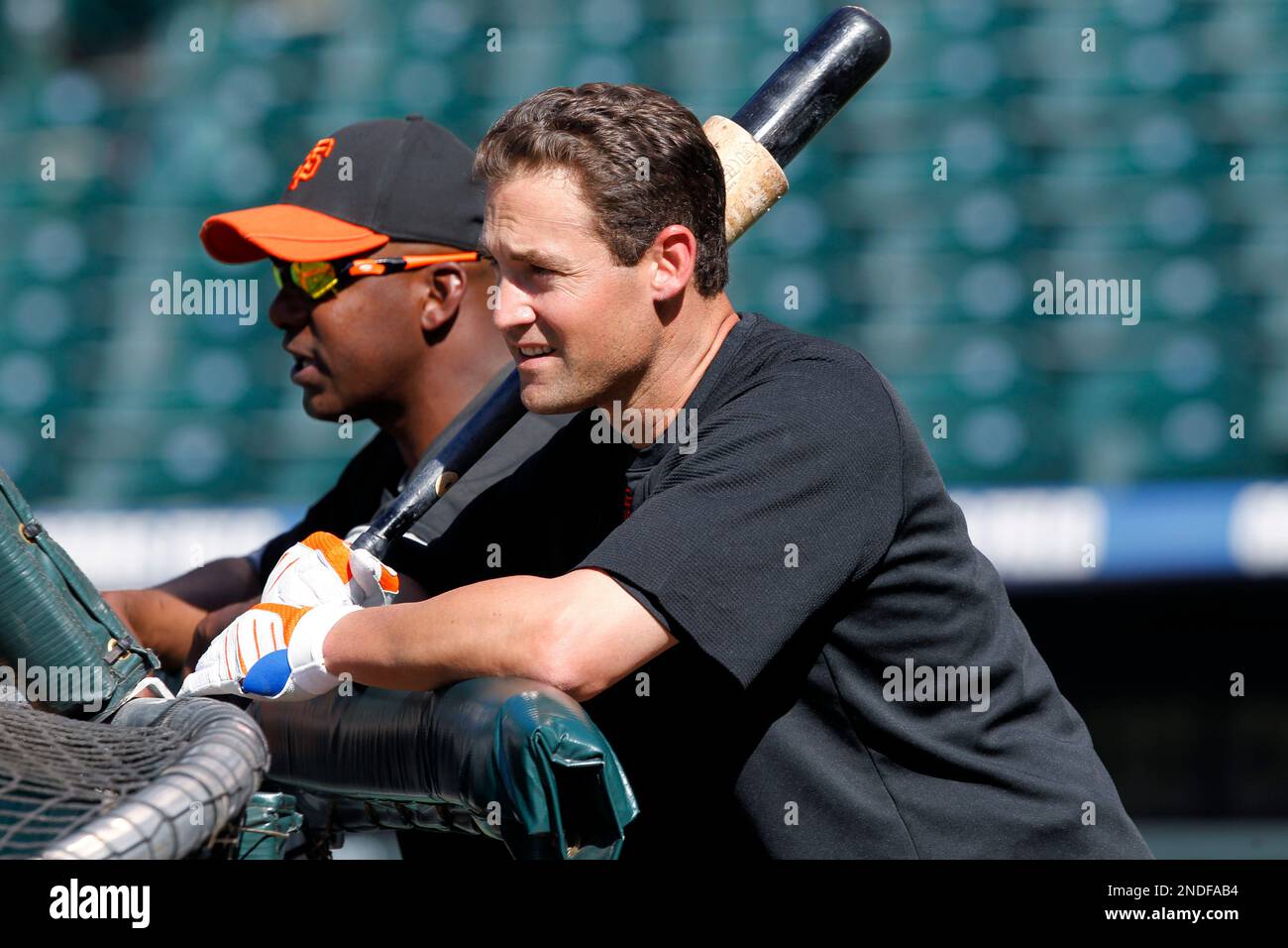 San Francisco Giants outfielder Pat Burrell, front, confers with coach ...