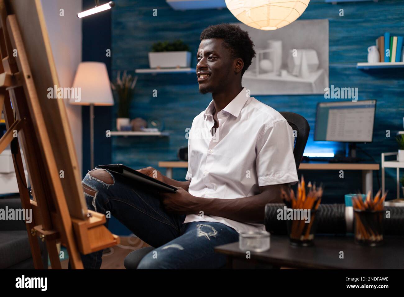 Young african american male cartoonist making digital copy of artwork ...