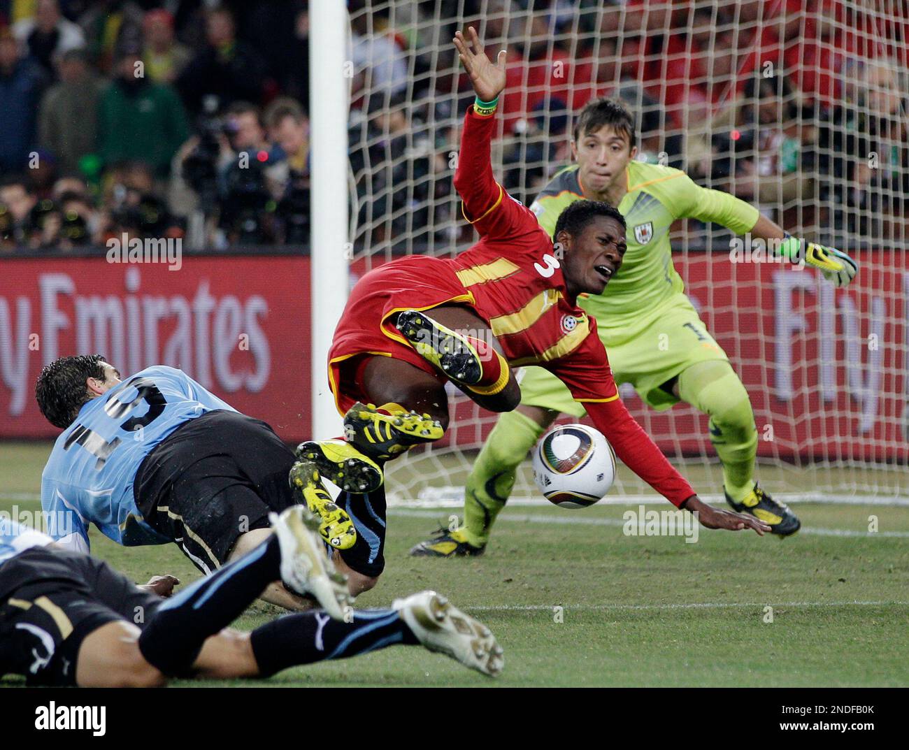 Ghana's Asamoah Gyan, center back, is tackled by Uruguay's Andres ...