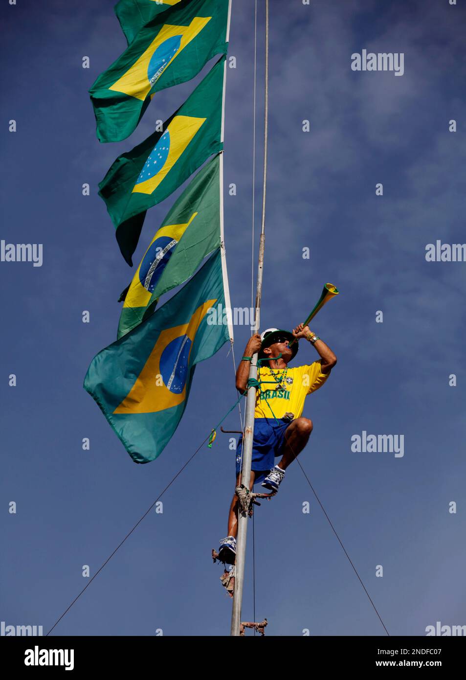 Manolo Manguera, a fan of Brazil's national soccer team blows a ...