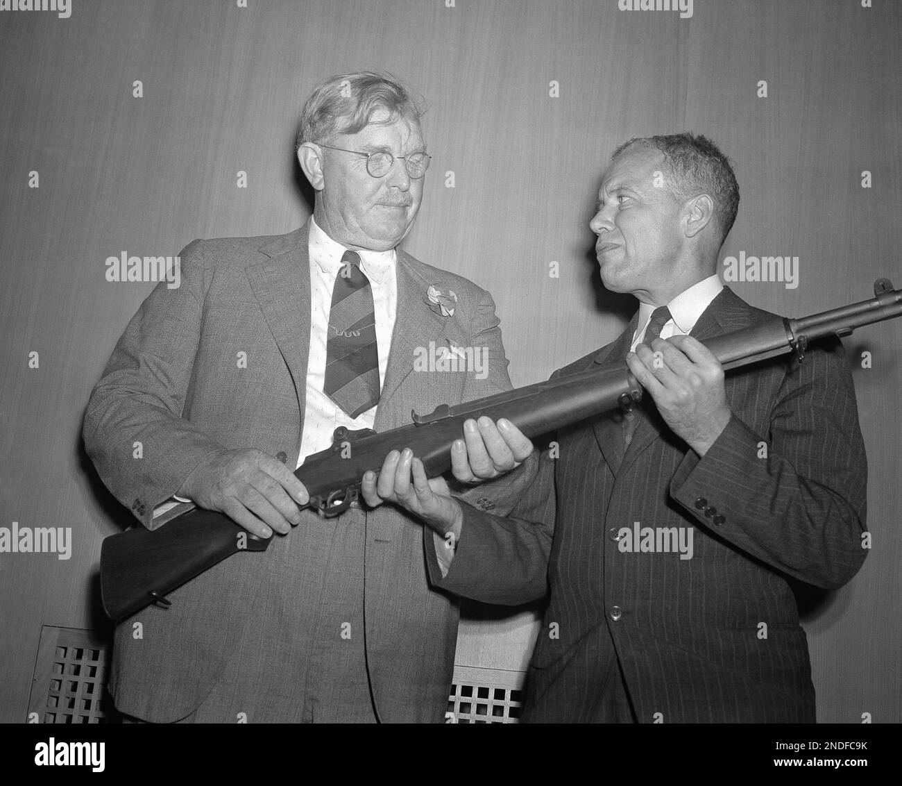 Sergt. Alvin York, left, World War hero, inspects a garand rifle with ...