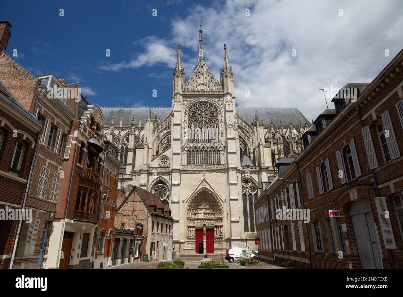 A scene of the beautiful Amiens Cathedral surrounded by buildings in ...