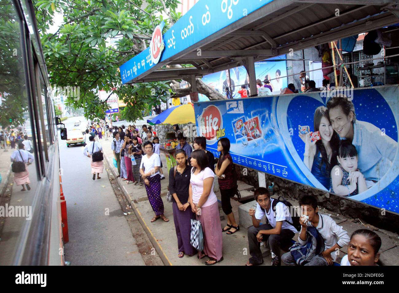Local peoples wait for bus at a bus-stop in downtown Yangon, Myanmar ...