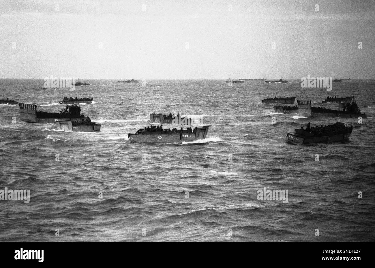 Landing barges loaded with invasion troops form up in the transport ...
