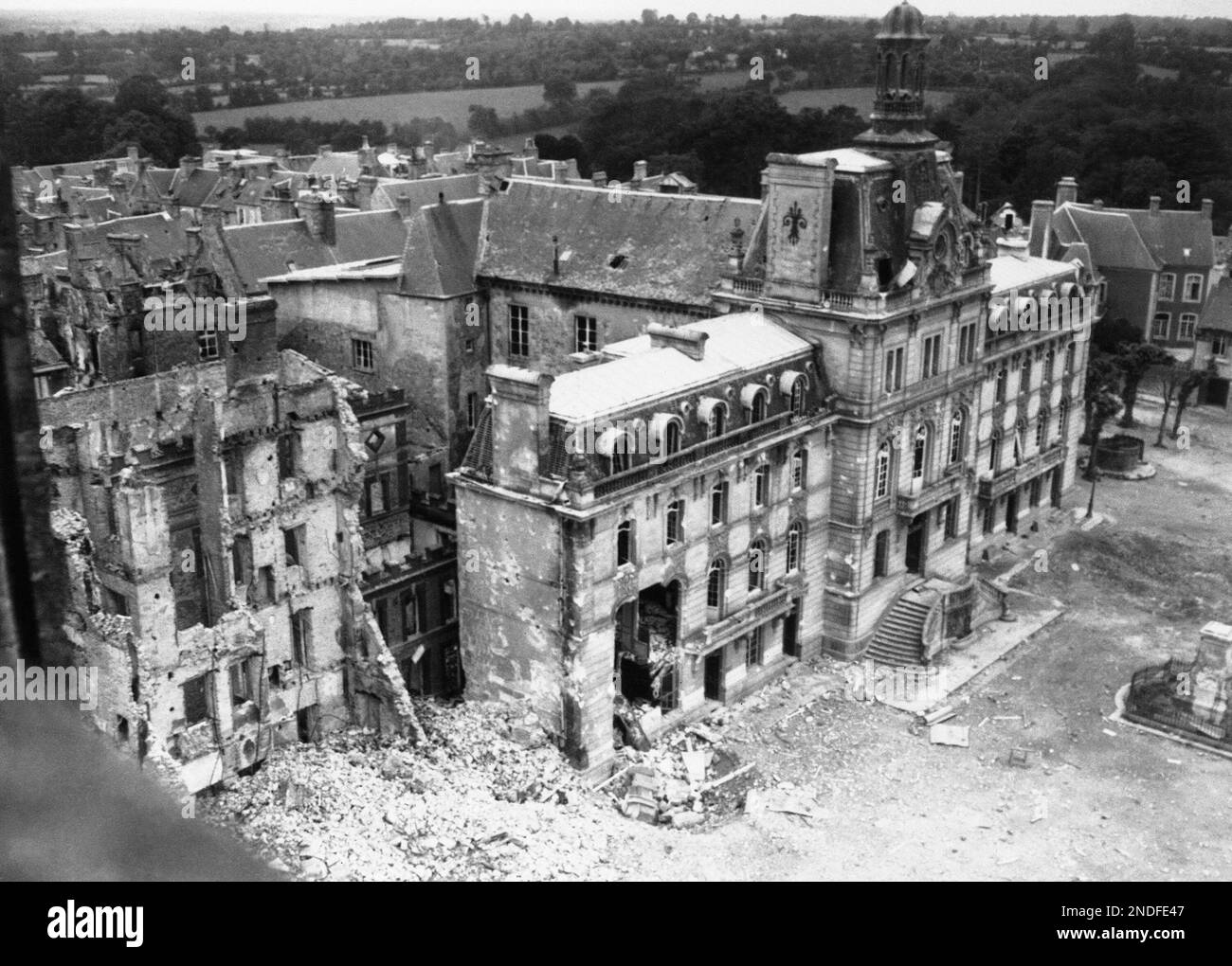 A view of the damage buildings on the main square of Coutances seen ...