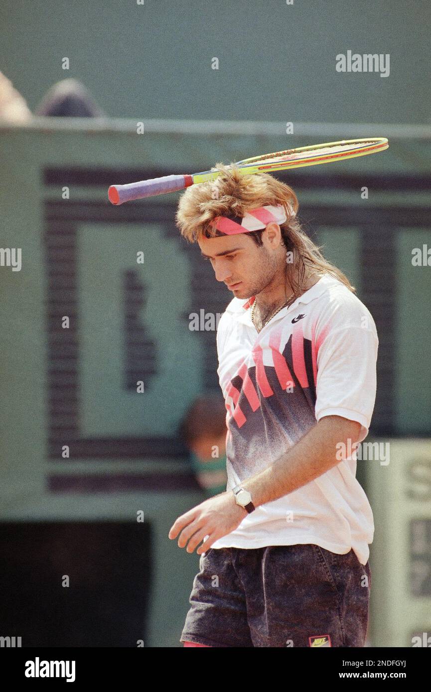 Andre Agassi of the U.S. leaves the court wearing his racket on his ...