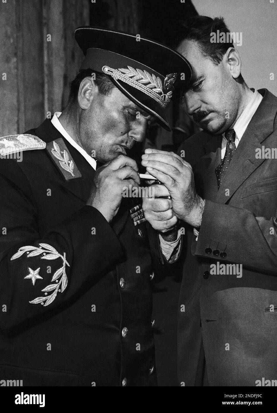 Marshal Josip Broz Tito gets a light for his cigarette from Nikola ...