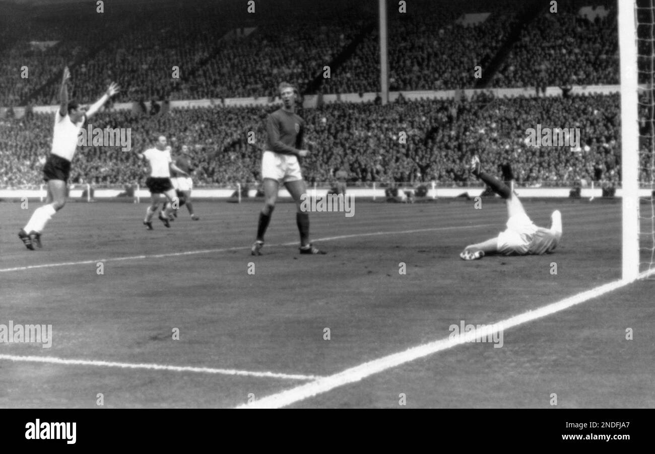 West Germany’s Lothar Emmerich raises his arms as Helmut Haller of ...