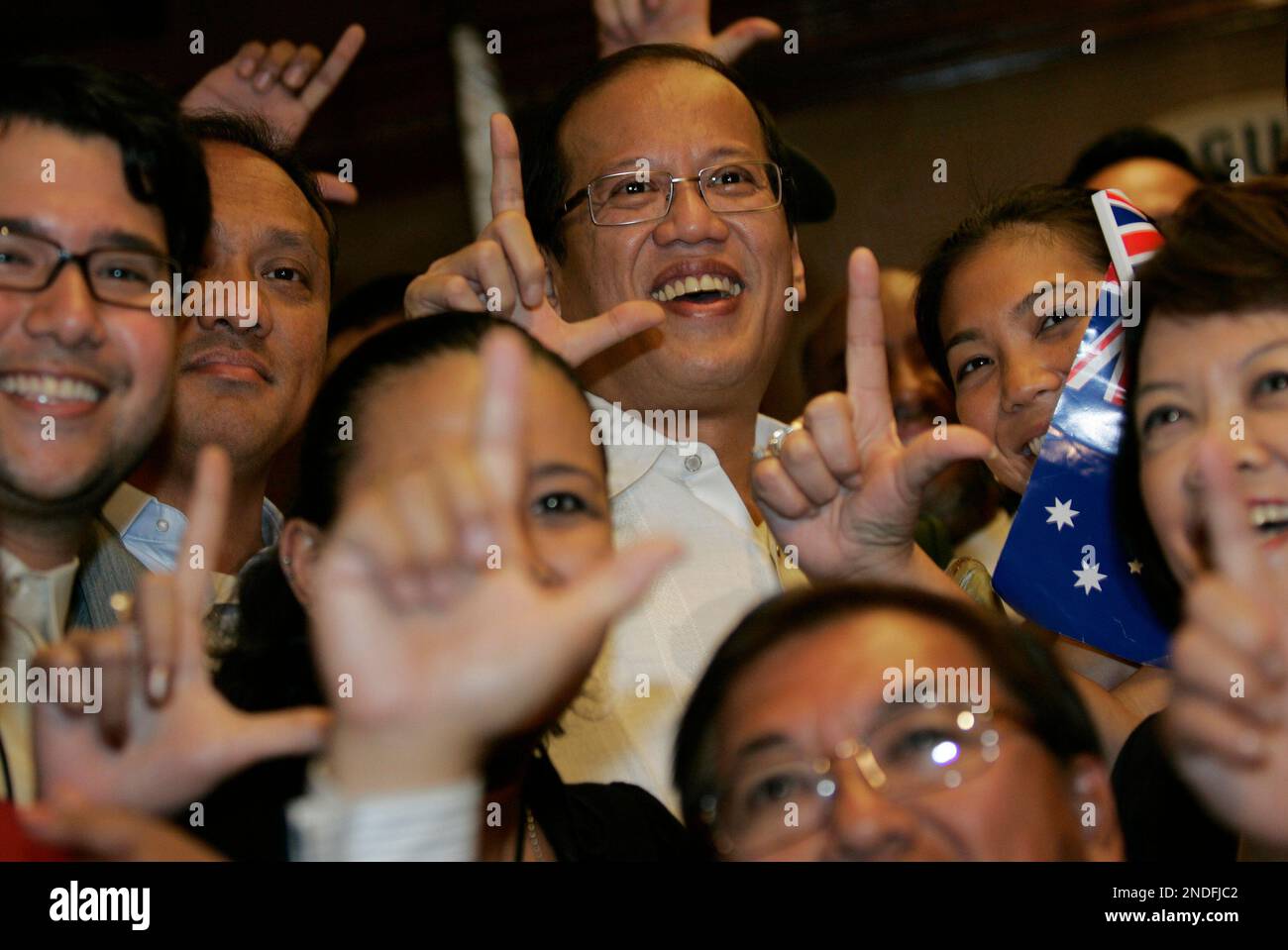 President Benigno Aquino III, center, flashes the "Laban" sign which ...