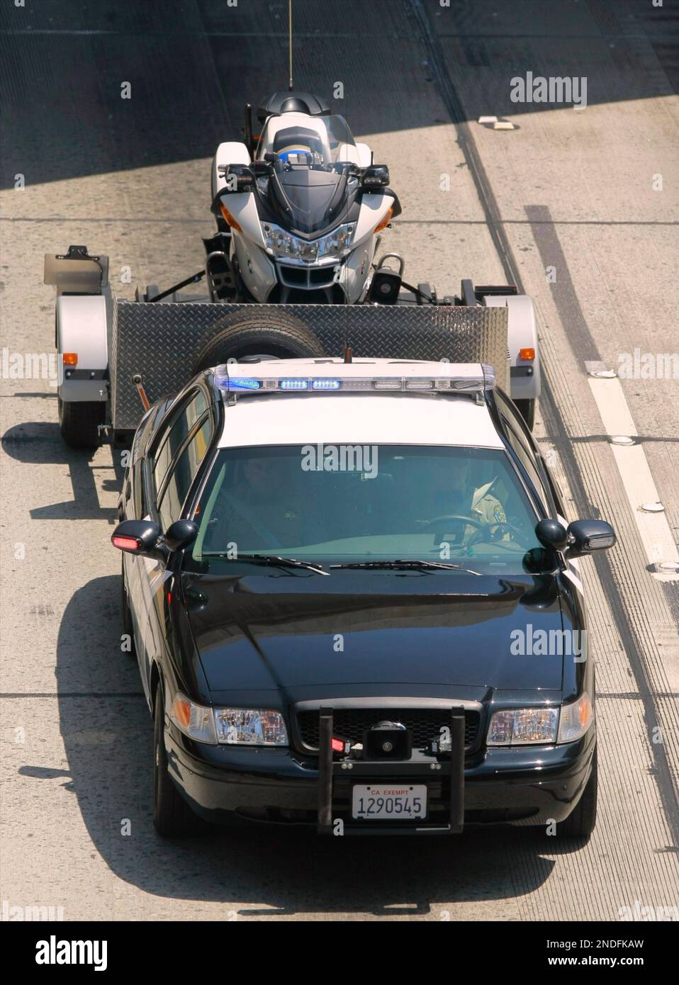 A ceremonial motorcycle is transported ahead of the hearse carrying the ...